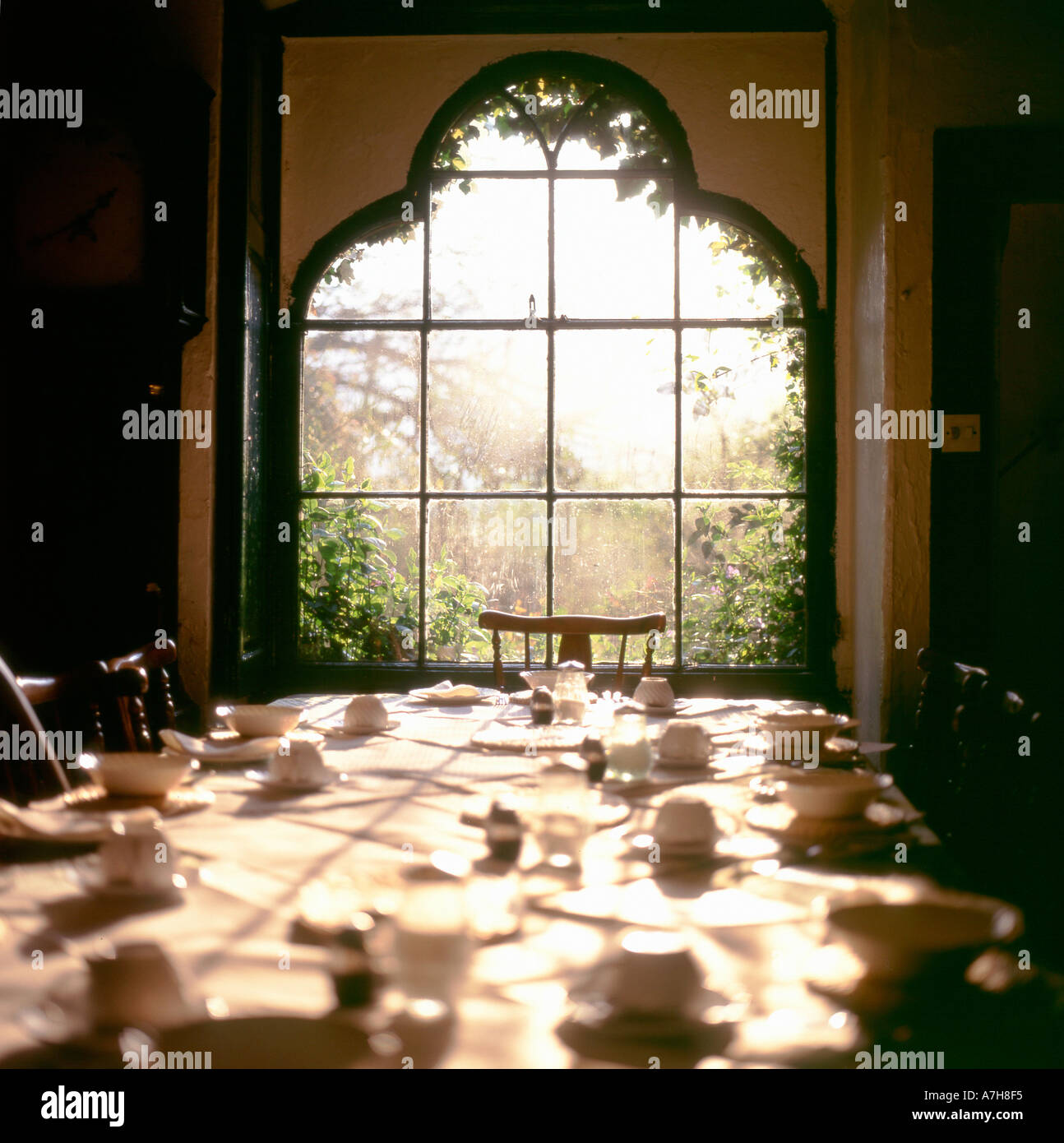 A table with cups and saucers in a country tea room with a beautiful ...