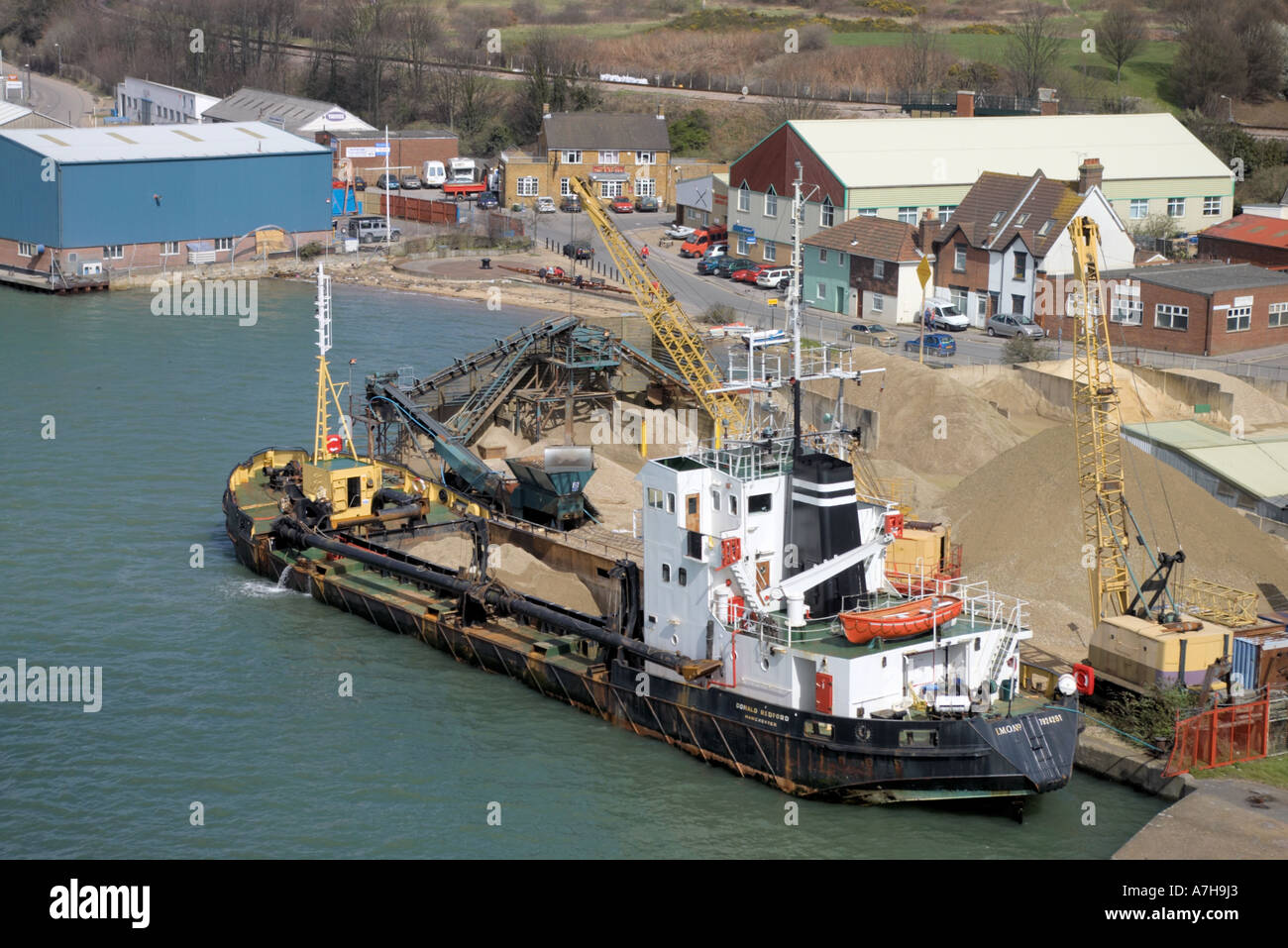 unloading sand from a ship in the River Itchen and Southampton harbour ...