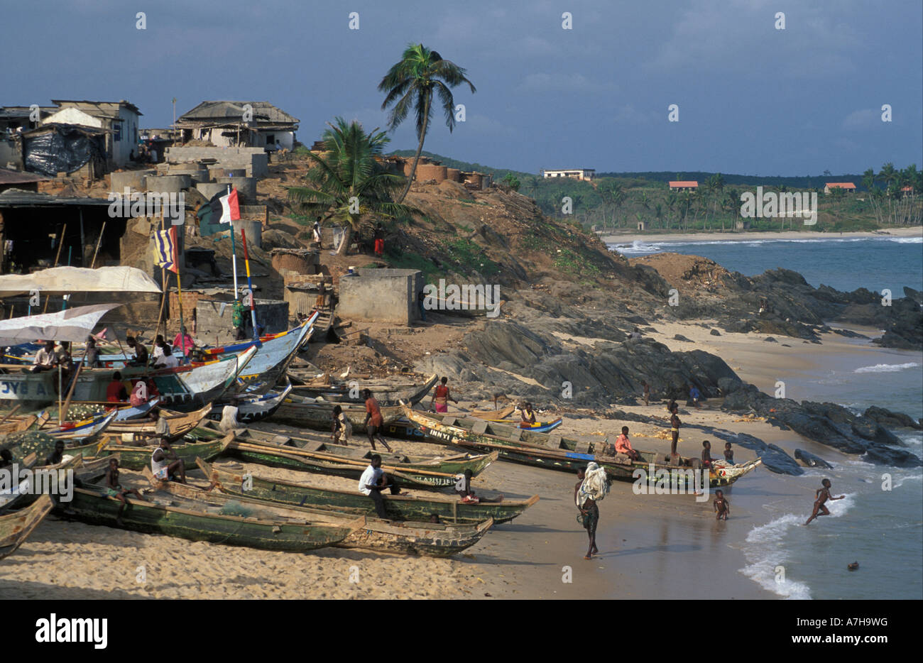 fishing pirogues lying on the beach in the village Biriwa, Ghana Stock ...