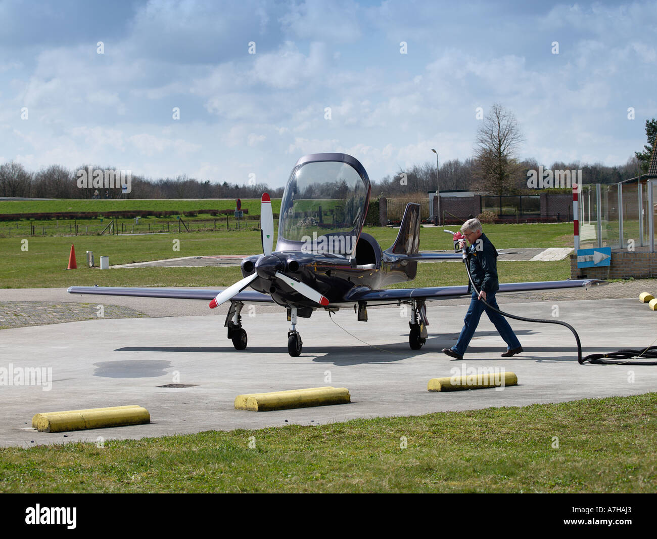 Hobby pilot fuelling his Lancair Legacy diy kit home built aeroplane ...