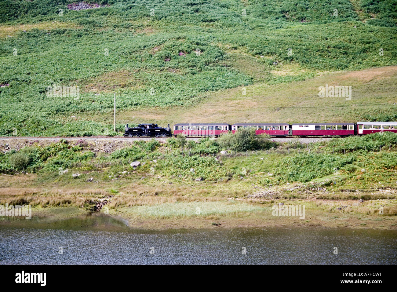 Steam train on the Ffestiniog railway passing Tanygrisiau reservoir ,Blaenau Ffestiniog,North ...