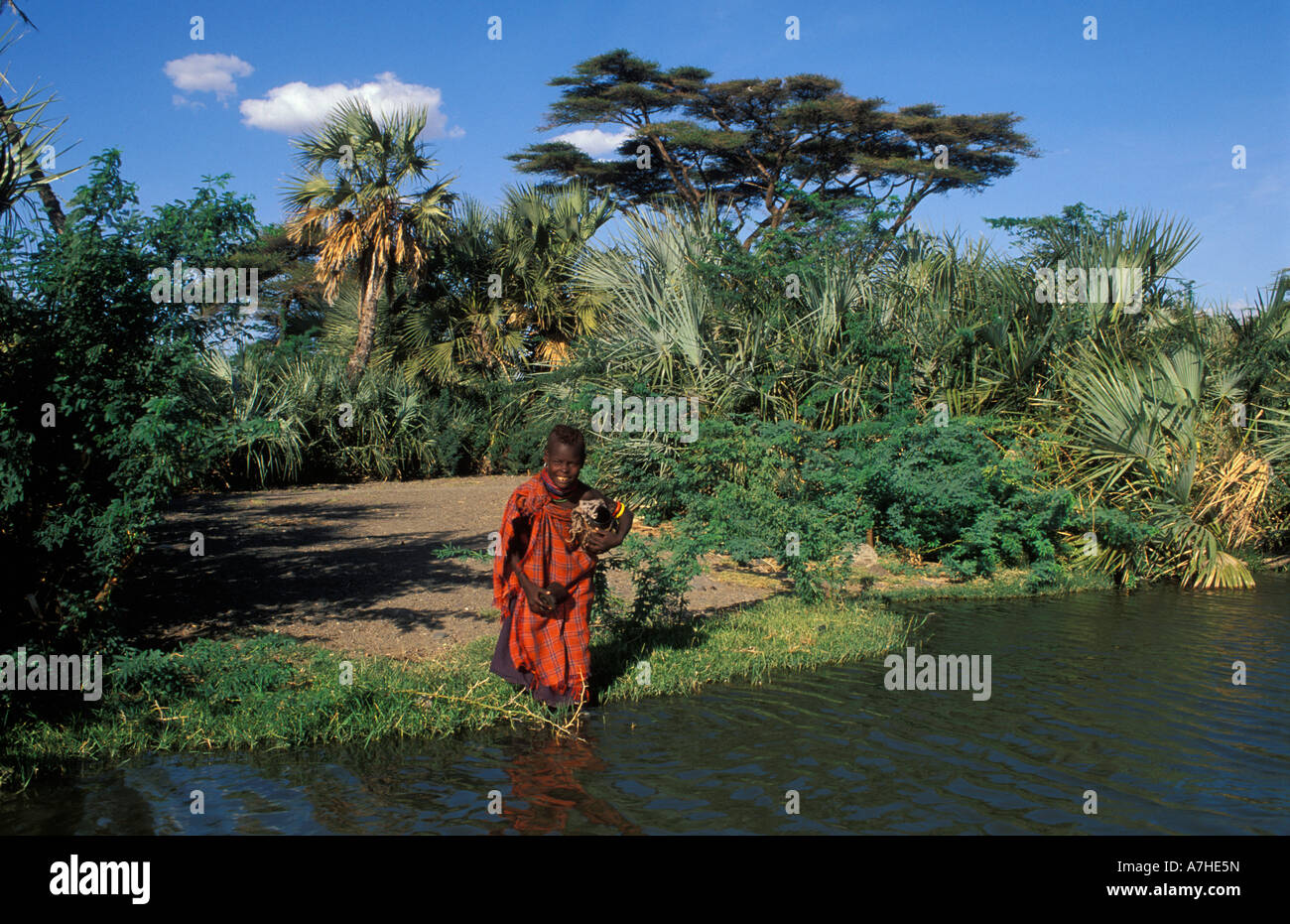 Turkana girl fetching water from the river, Loiyangalani on the shore ...