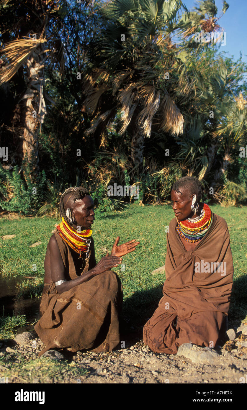 Turkana women sitting next to the river, Loiyangalani, on the shore of ...