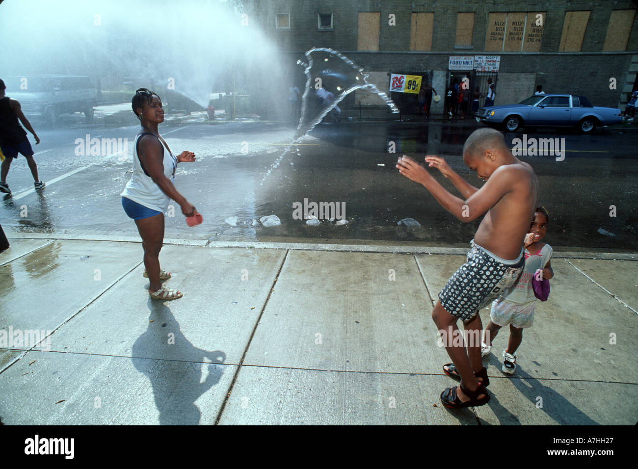 USA, IL, Chicago. Residents of Chicago's tough West Side cool off from ...