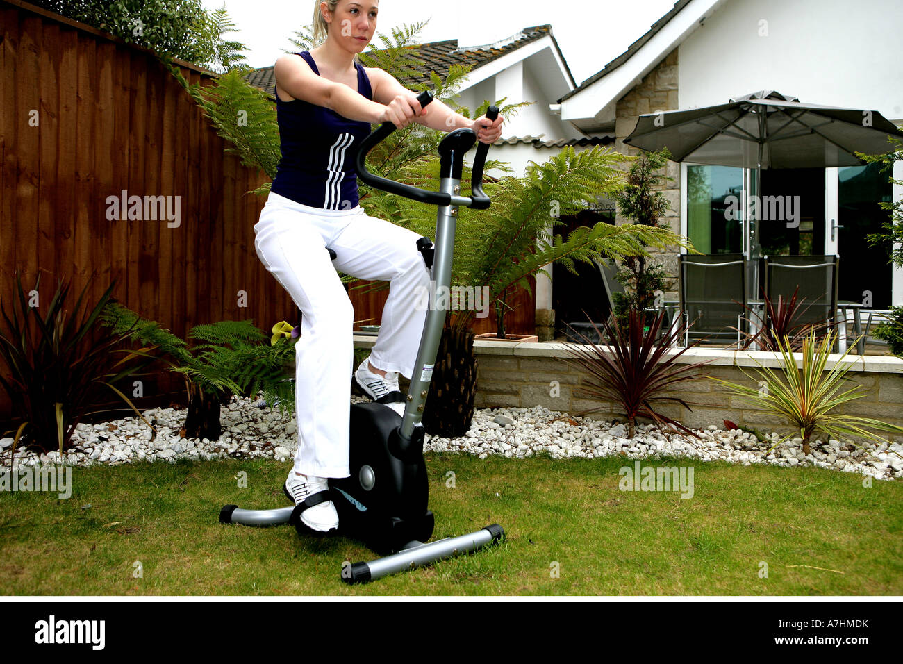 Young Woman on Exercise Bike Model Released Stock Photo - Alamy