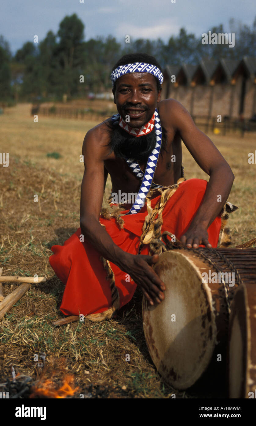 Drummer heating the drums before playing. Intore dance group at the ...