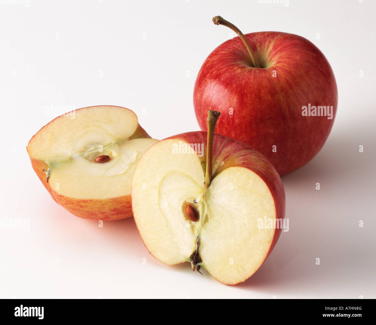 A whole and cut Gala apples on a white background editorial food Stock ...