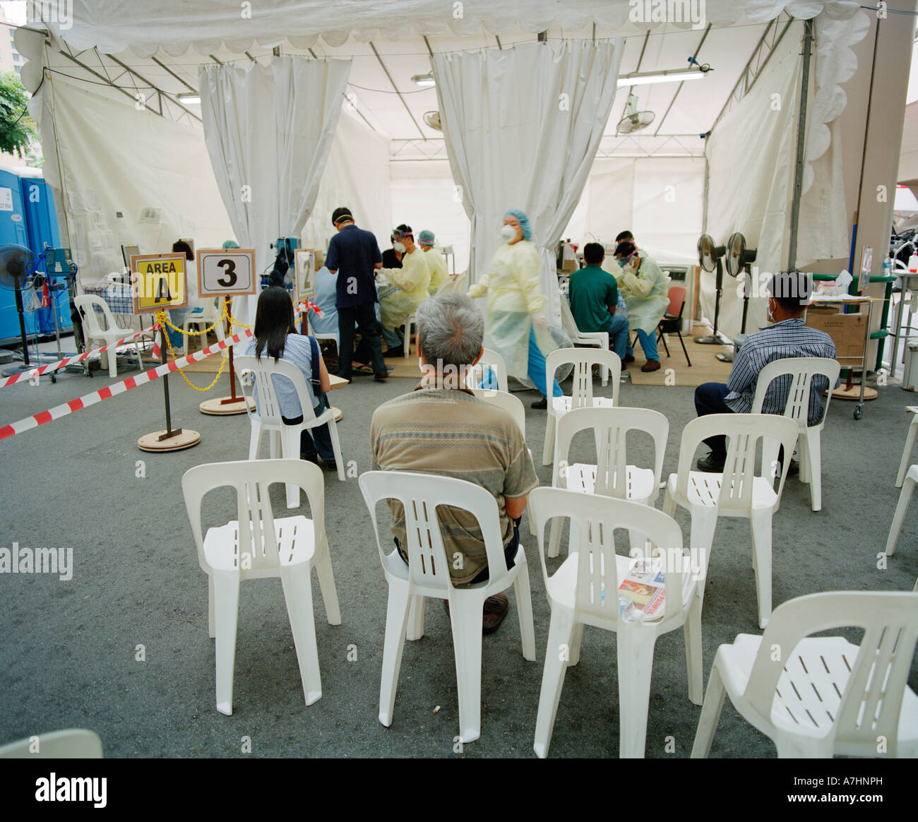 Doctors work in a temporary outdoor clinic set up during the SARS ...