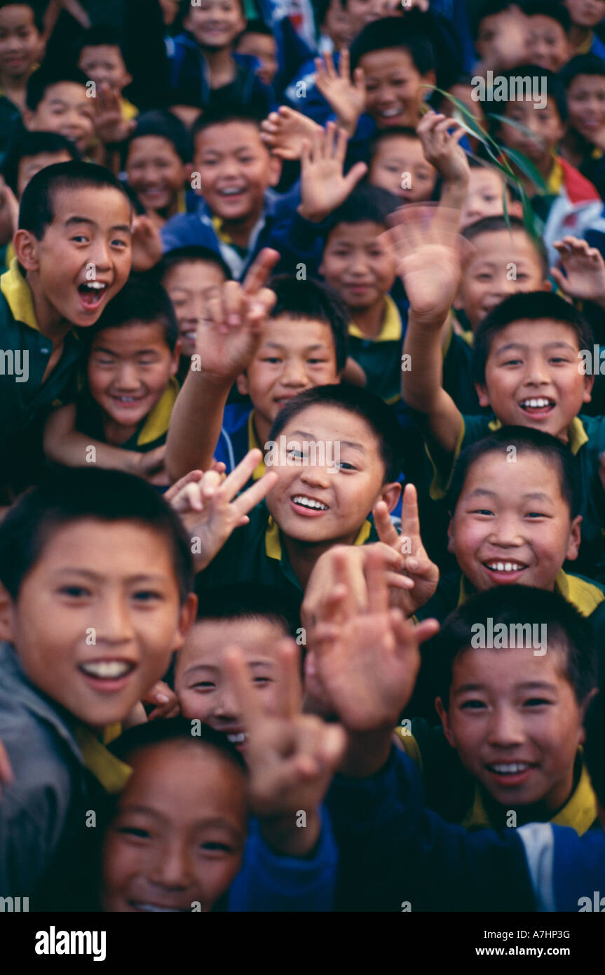 A group of young Chinese boys smiling and waving to the camera Stock ...