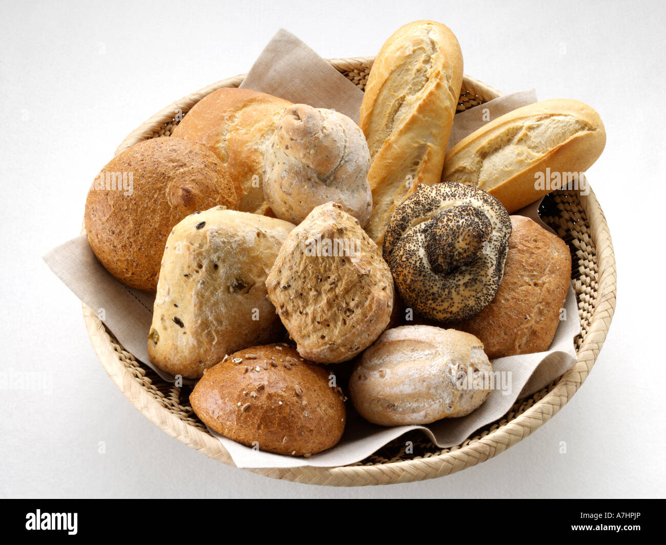 A variety of rolls in a basket on a white background editorial food ...