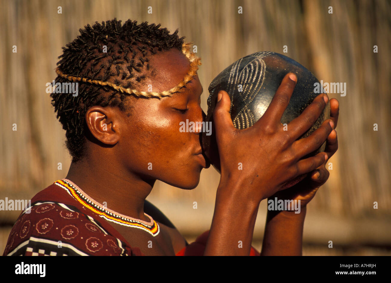 Boy drinking porridge from clay bowl Mantenga village Swaziland Stock ...