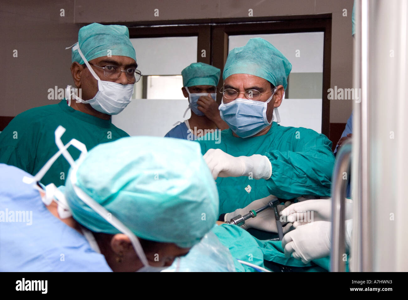 A group of surgeons and nurses in-between surgery inside the operation ...
