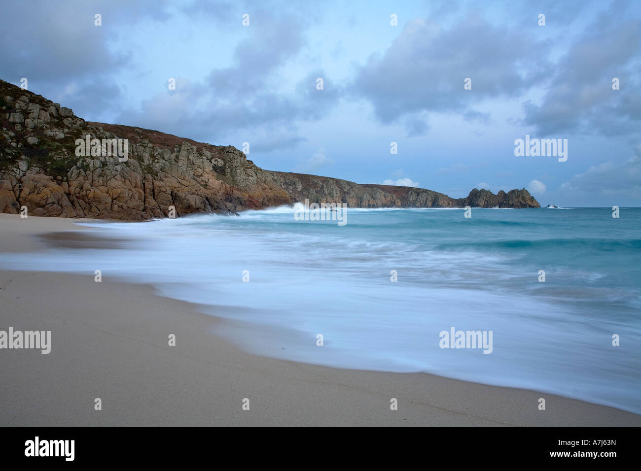 Logan Rock seen from Porthcurno beach Cornwall at sunset Stock Photo ...