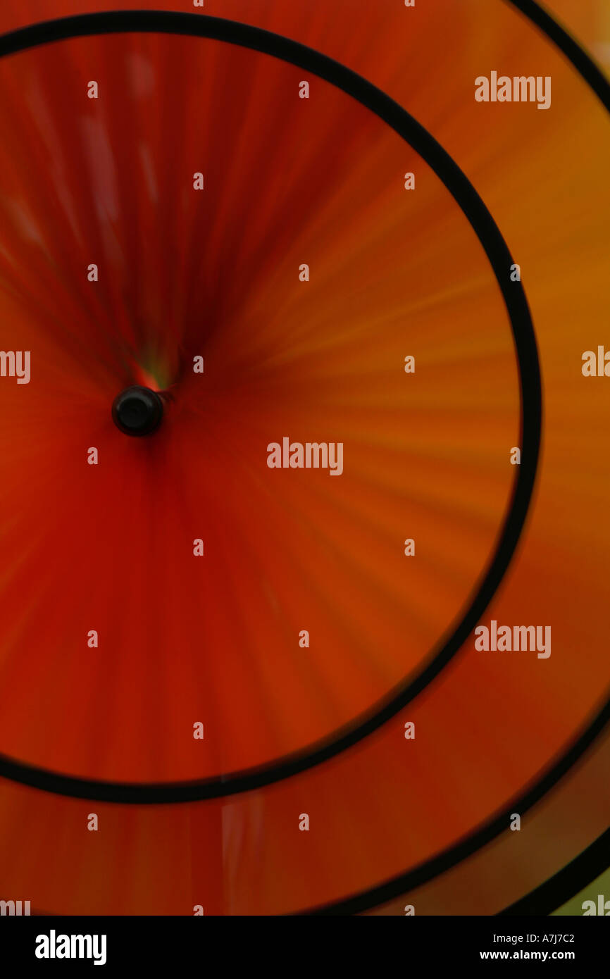 An orange windmill spinner spinning in the breeze at Stanmer Park ...