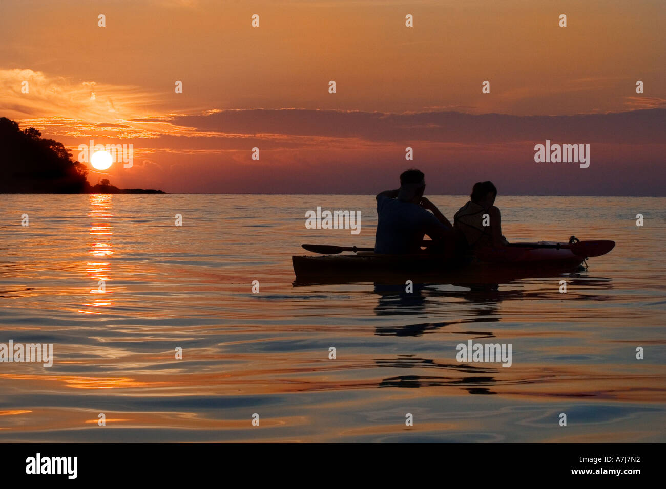 Travelers enjoy an early morning kayak paddle in the North Andaman Sea ...