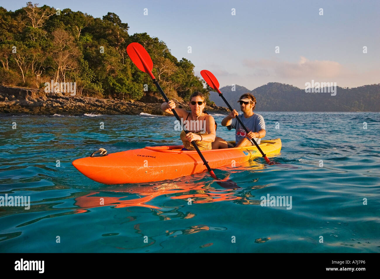 Travelers enjoy an early morning kayak paddle in the North Andaman Sea ...
