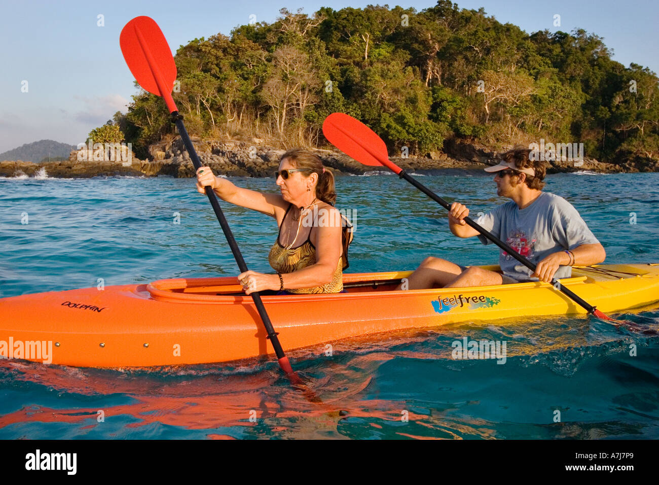 Travelers enjoy an early morning kayak paddle in the North Andaman Sea ...