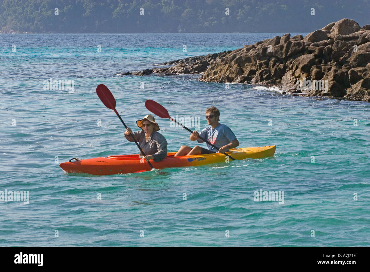 Travelers enjoy an early morning kayak paddle in the North Andaman Sea ...
