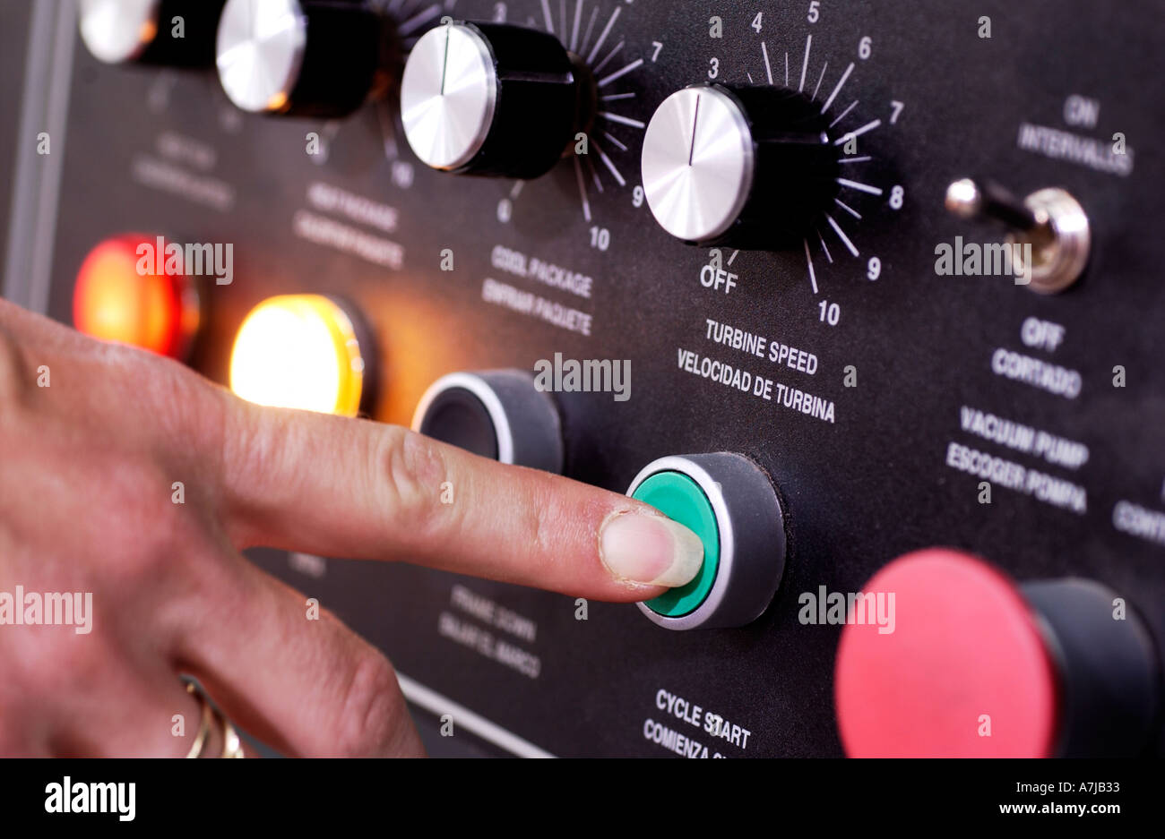 Factory worker pushing button on sealing machine Stock Photo - Alamy