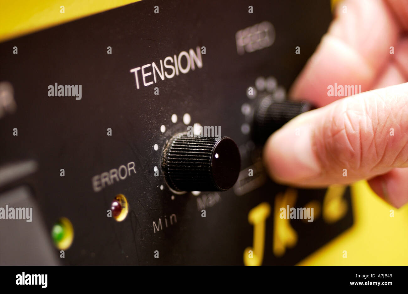 Factory worker adjusting knob on industrial strapping machine Stock ...