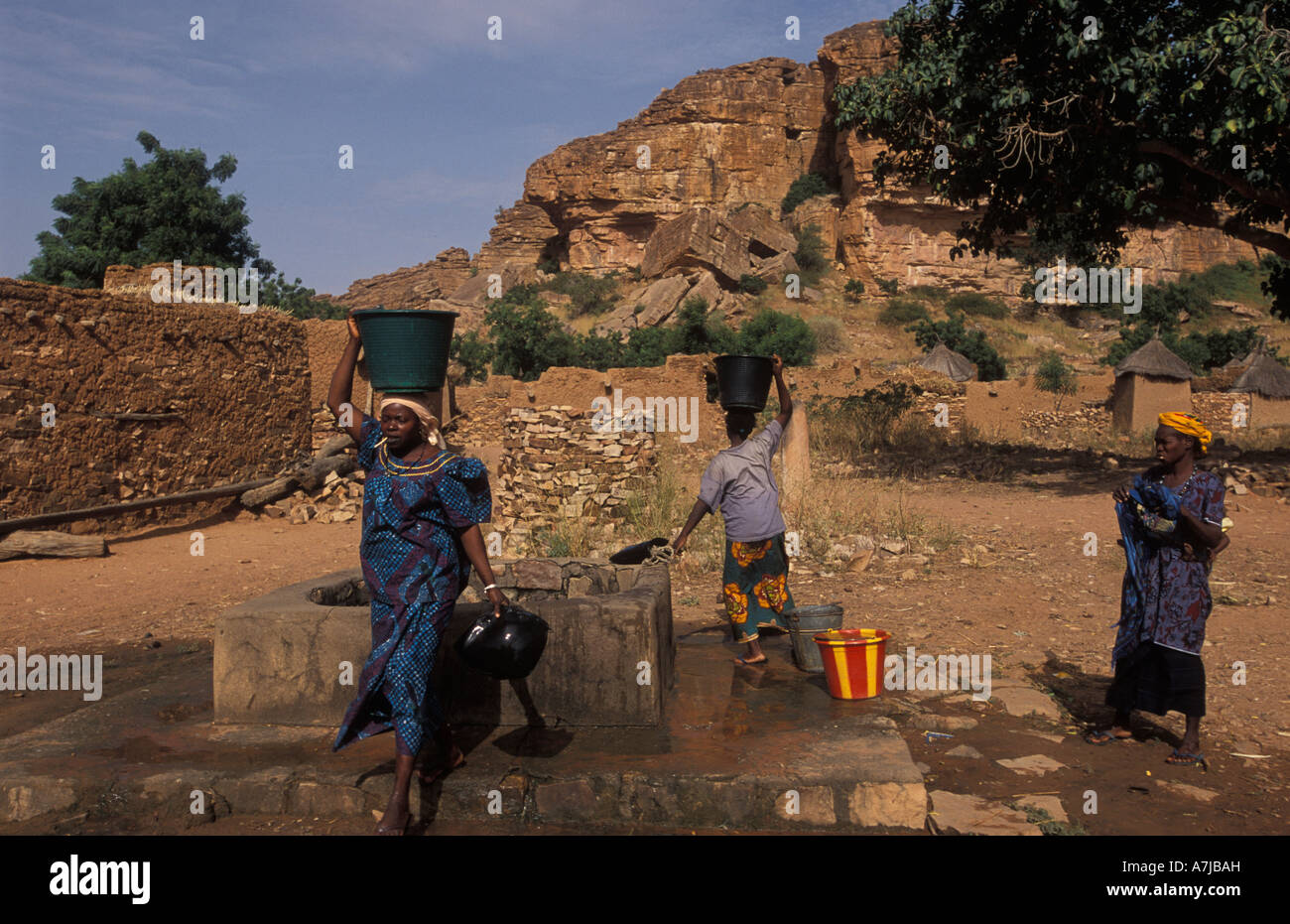 women collecting water from the village well, Songo, Dogon Country ...