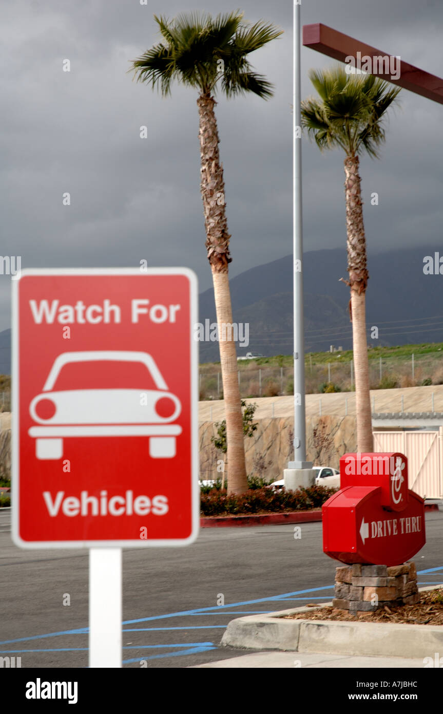 Warning sign reading 'Watch for Vehicles' at drive-thru crossing Stock ...