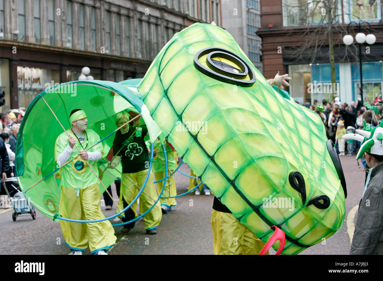 Large green theatrical snake held up by people as part of the St ...