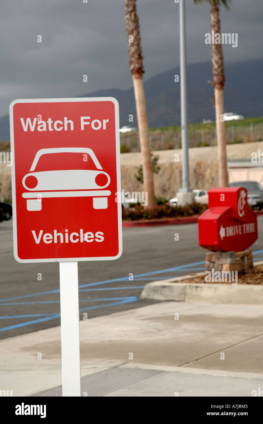 Warning sign reading 'Watch for Vehicles' at drive-thru crossing Stock ...