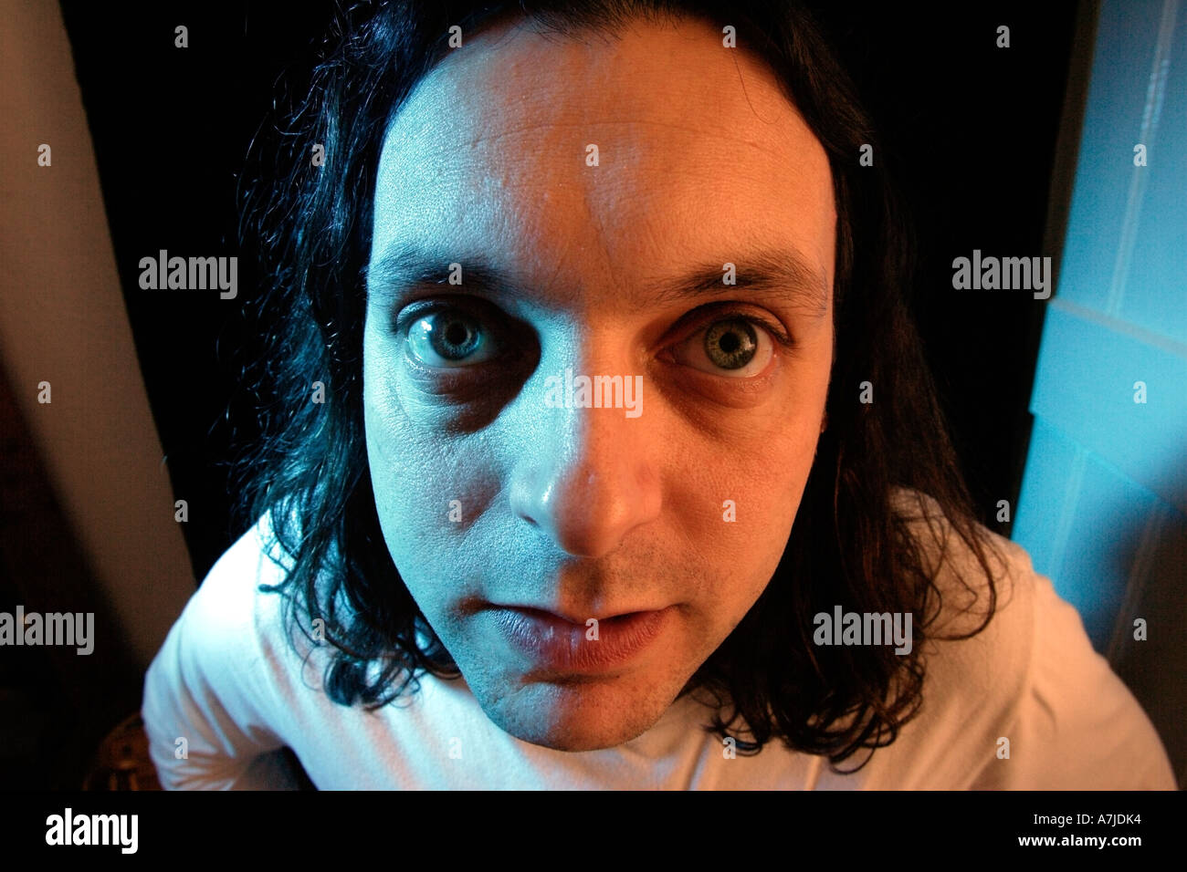 wild-eyed man staring up at viewer Stock Photo - Alamy