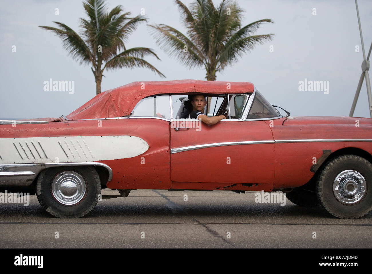 Cuban driver in an American 1950's convertible on the Via Monumental ...