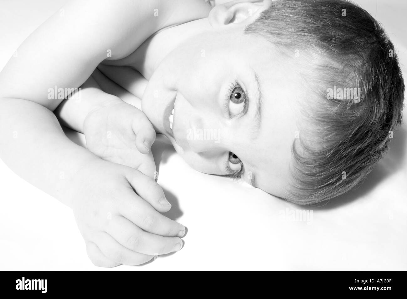 2 Year Old Boy Lying Down Looking Wide Eyed Into Camera Stock Photo Alamy 2-year-old-boy-lying-down-looking-wide-eyed-into-camera-stock-photo-alamy