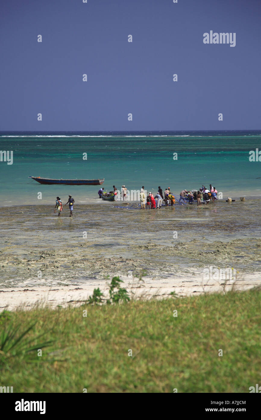Local people buying fish on the beach Stock Photo - Alamy
