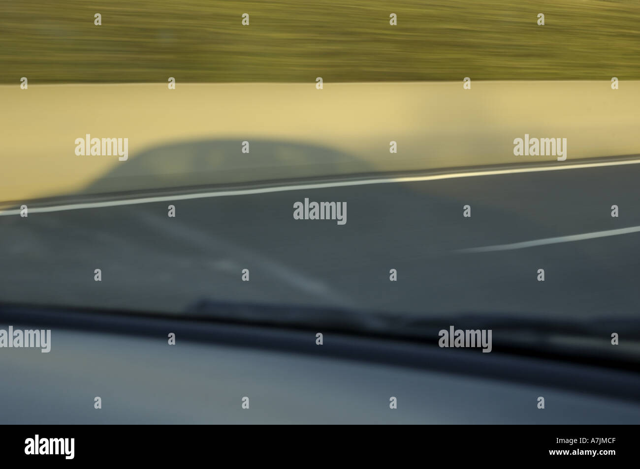 Speeding car shadow on the road Stock Photo - Alamy