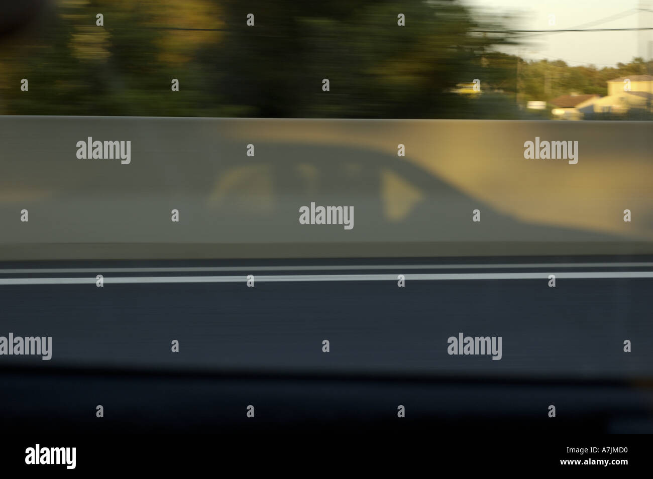 Speeding car shadow on the road Stock Photo - Alamy