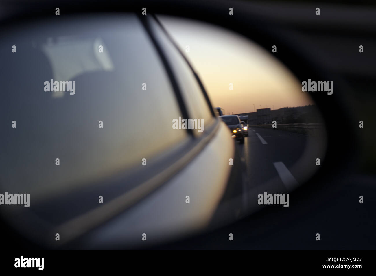 Left side rear view mirror reflecting traffic on the highway Stock ...