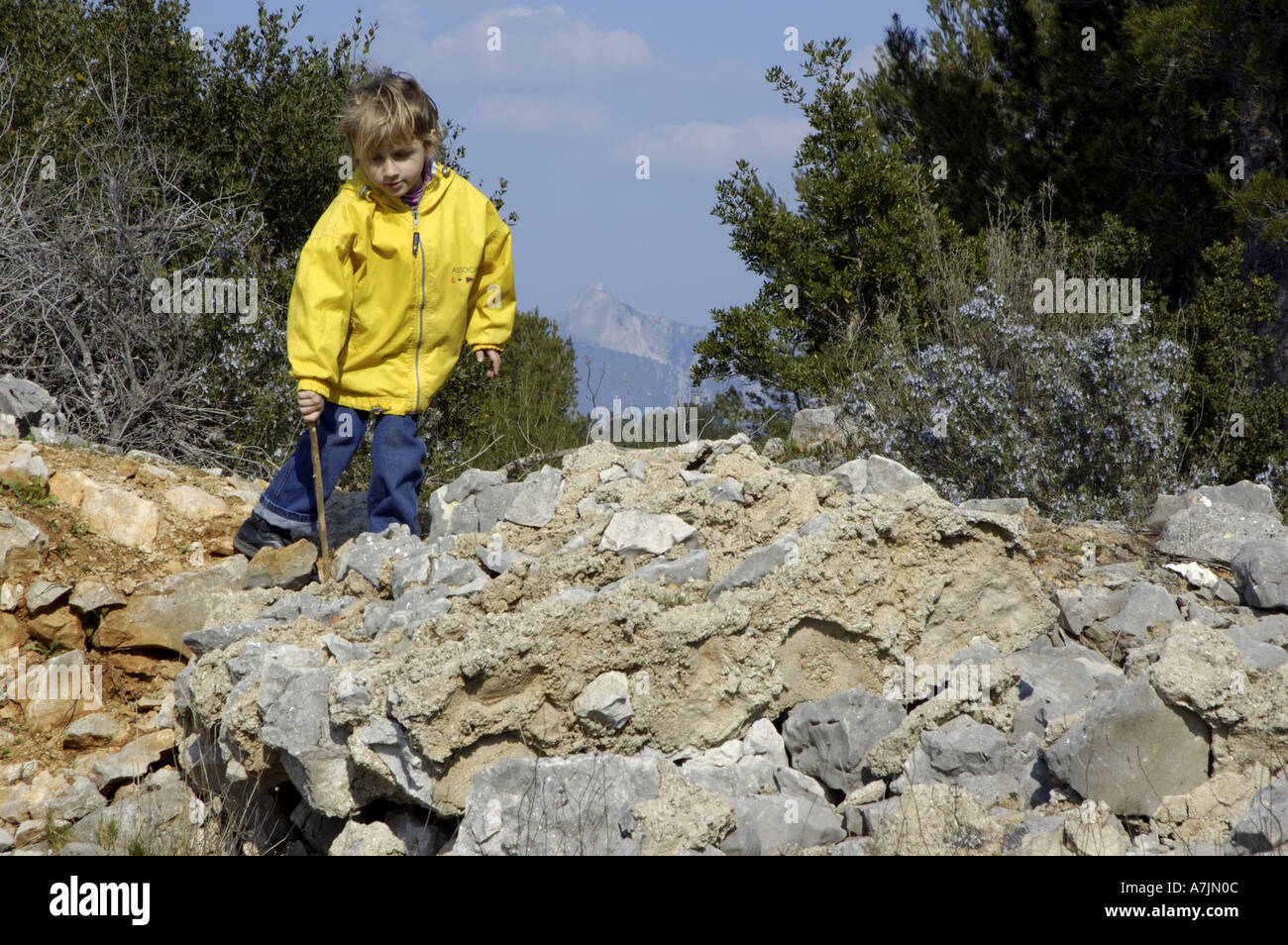 A little girl playing with rocks Stock Photo - Alamy