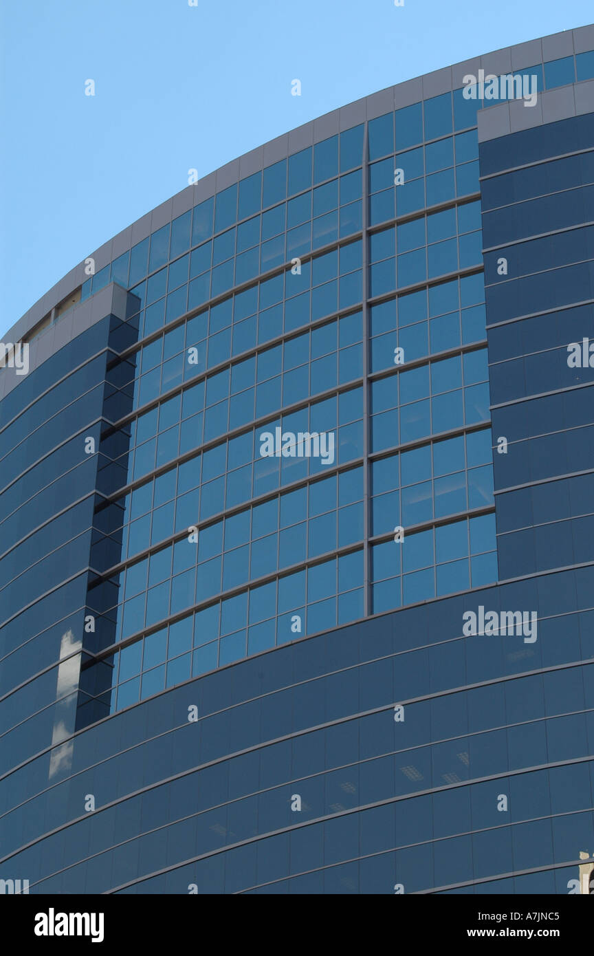 Curved glass hi res building against blue sky Stock Photo - Alamy