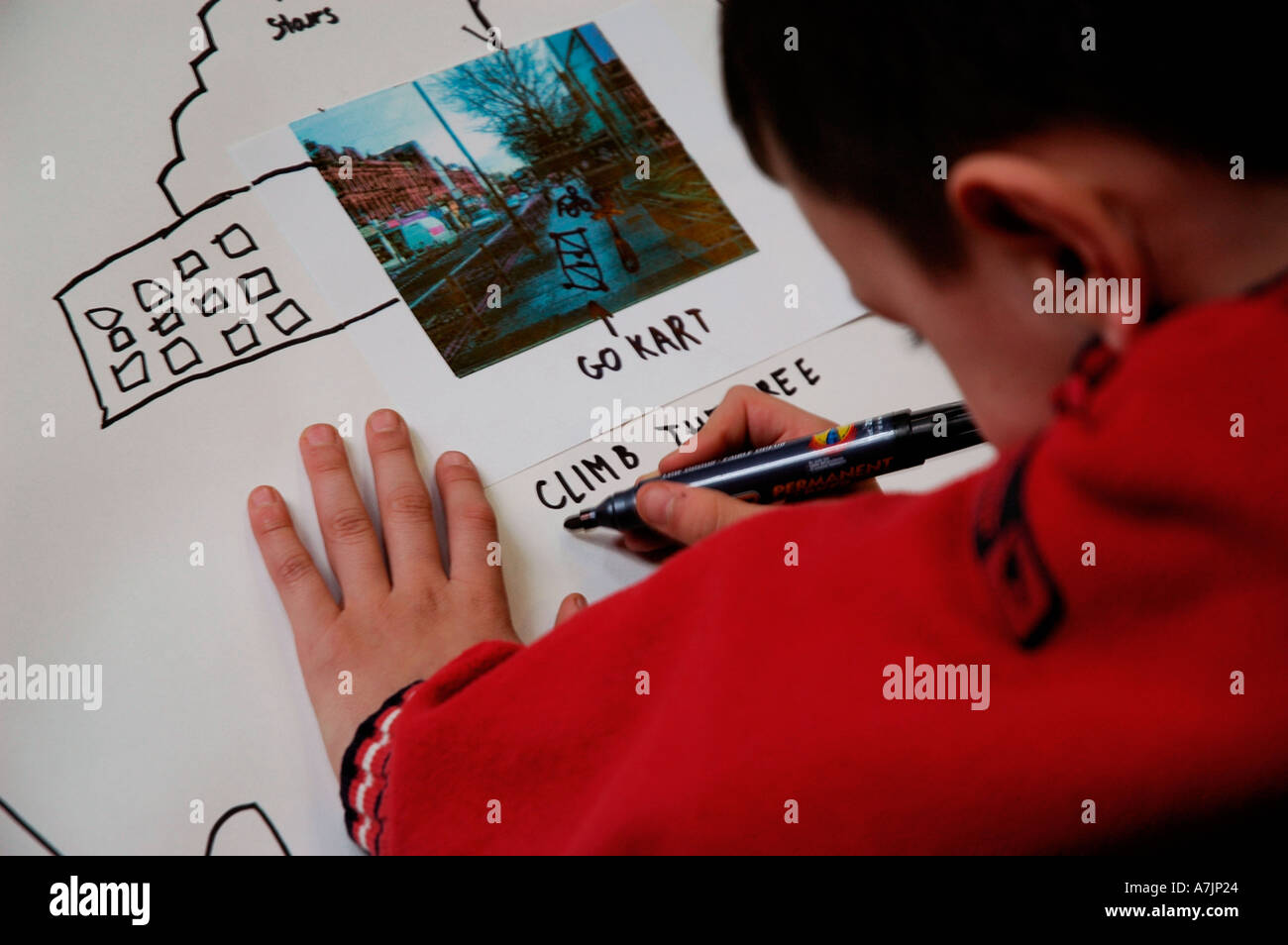 Young boy creative writing and drawing in class at school Stock Photo ...