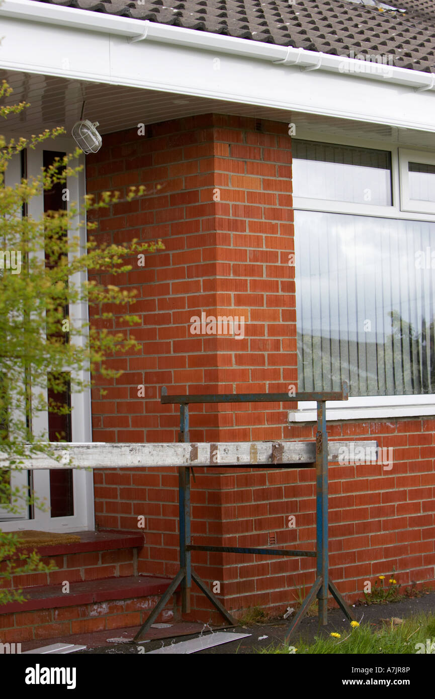 front porch of a house with scaffolding during installation of white ...