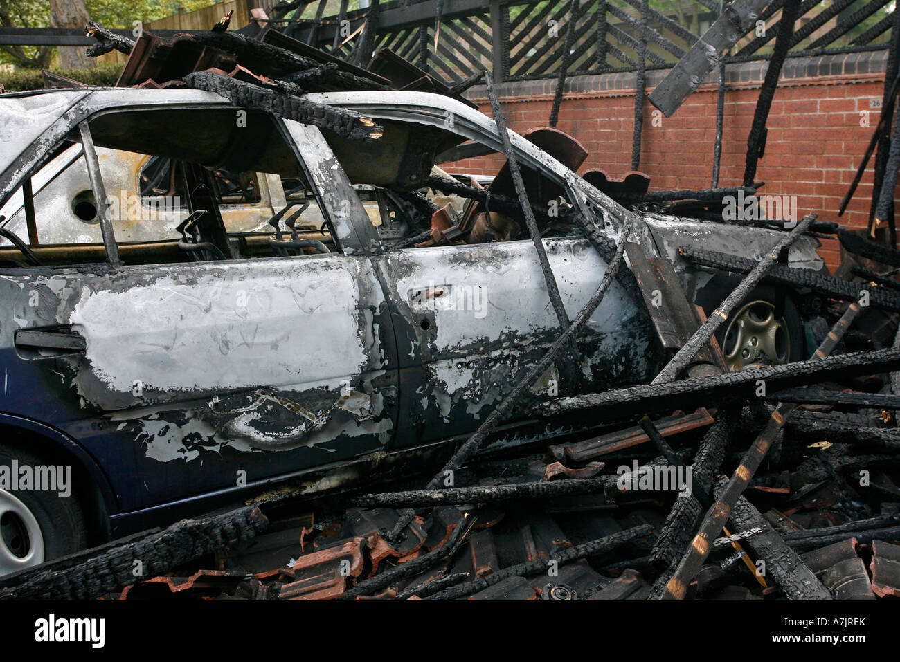 Burnt out car and carport Stock Photo - Alamy