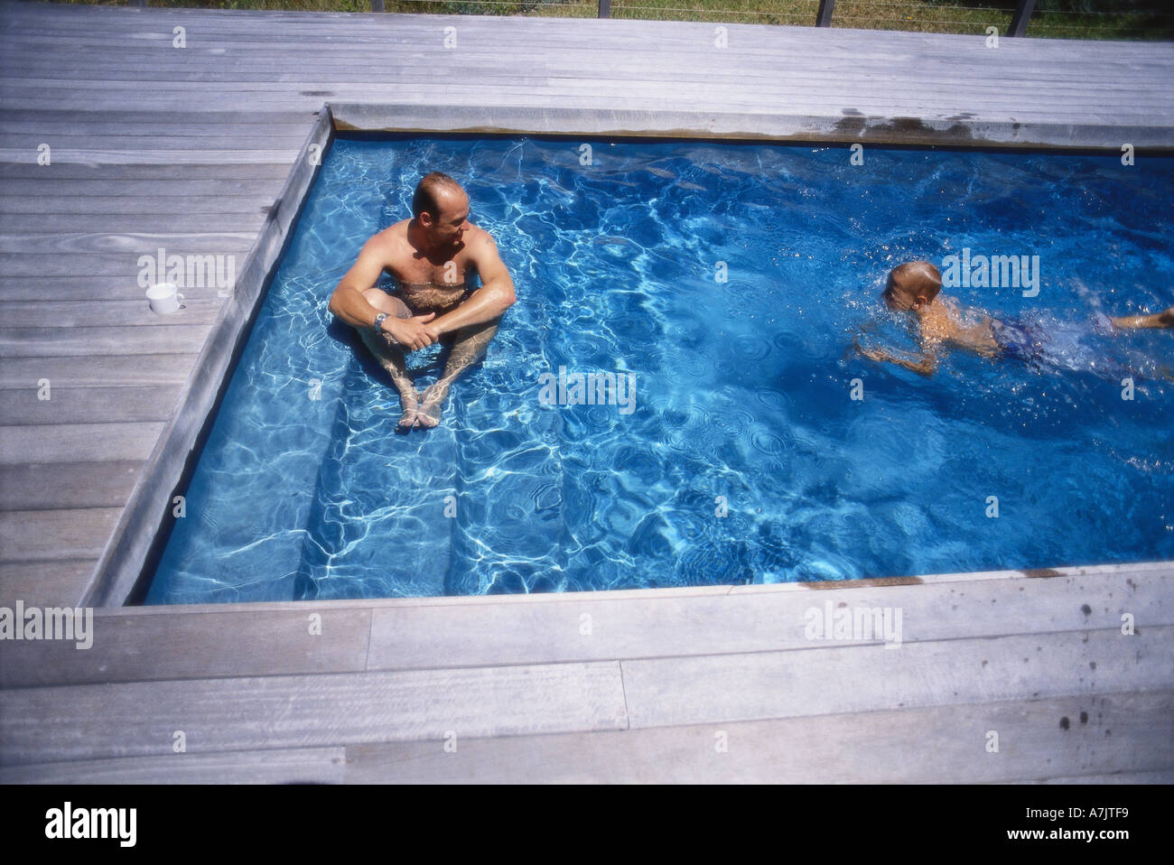 High angle view of a father and son in a swimming pool Stock Photo - Alamy