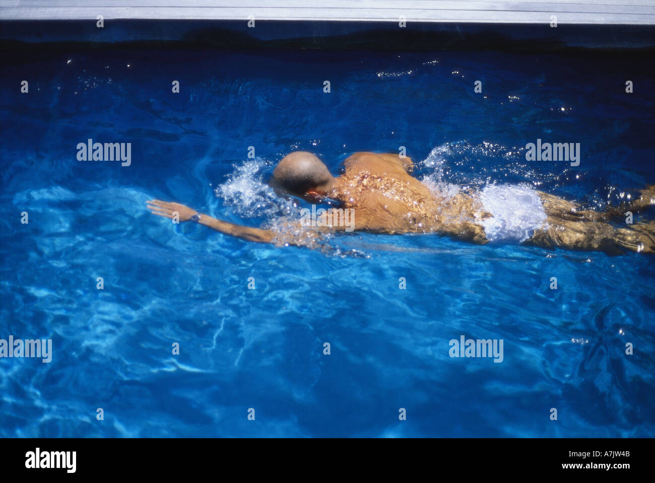 Side profile of a young man swimming in a pool Stock Photo - Alamy