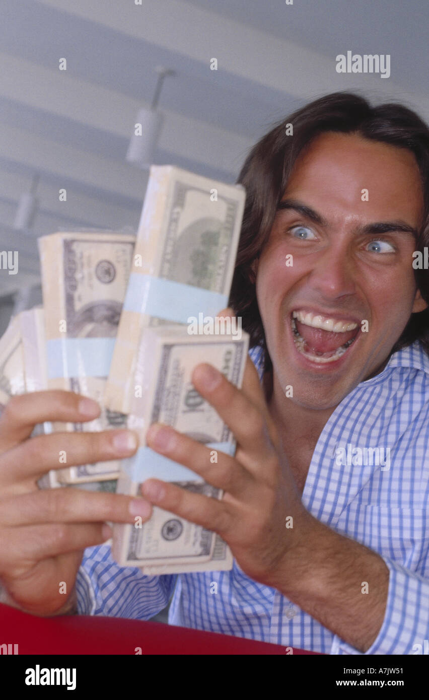 Man with wads of money hi-res stock photography and images - Alamy