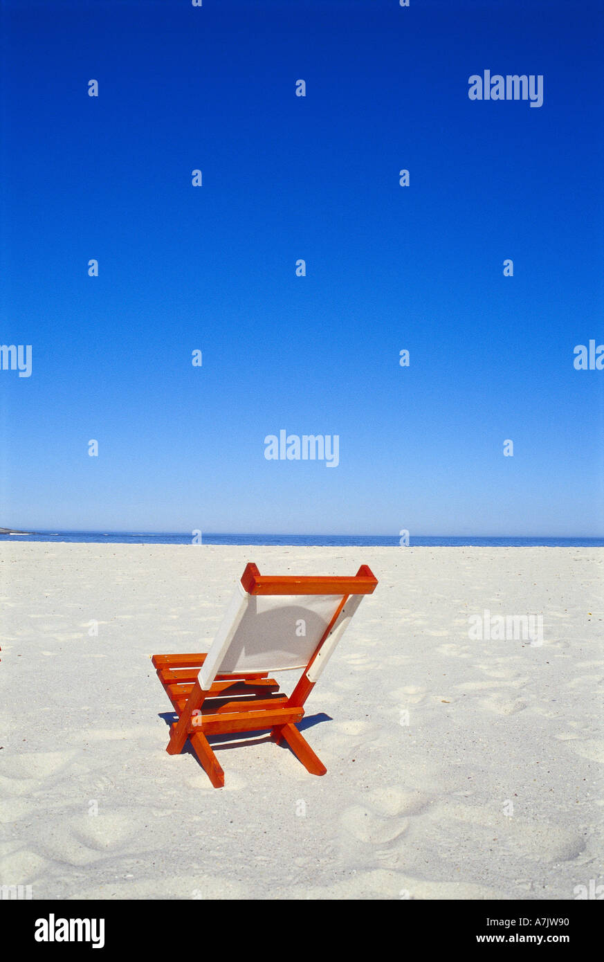 Rear view of a deck chair lying on the beach Stock Photo - Alamy