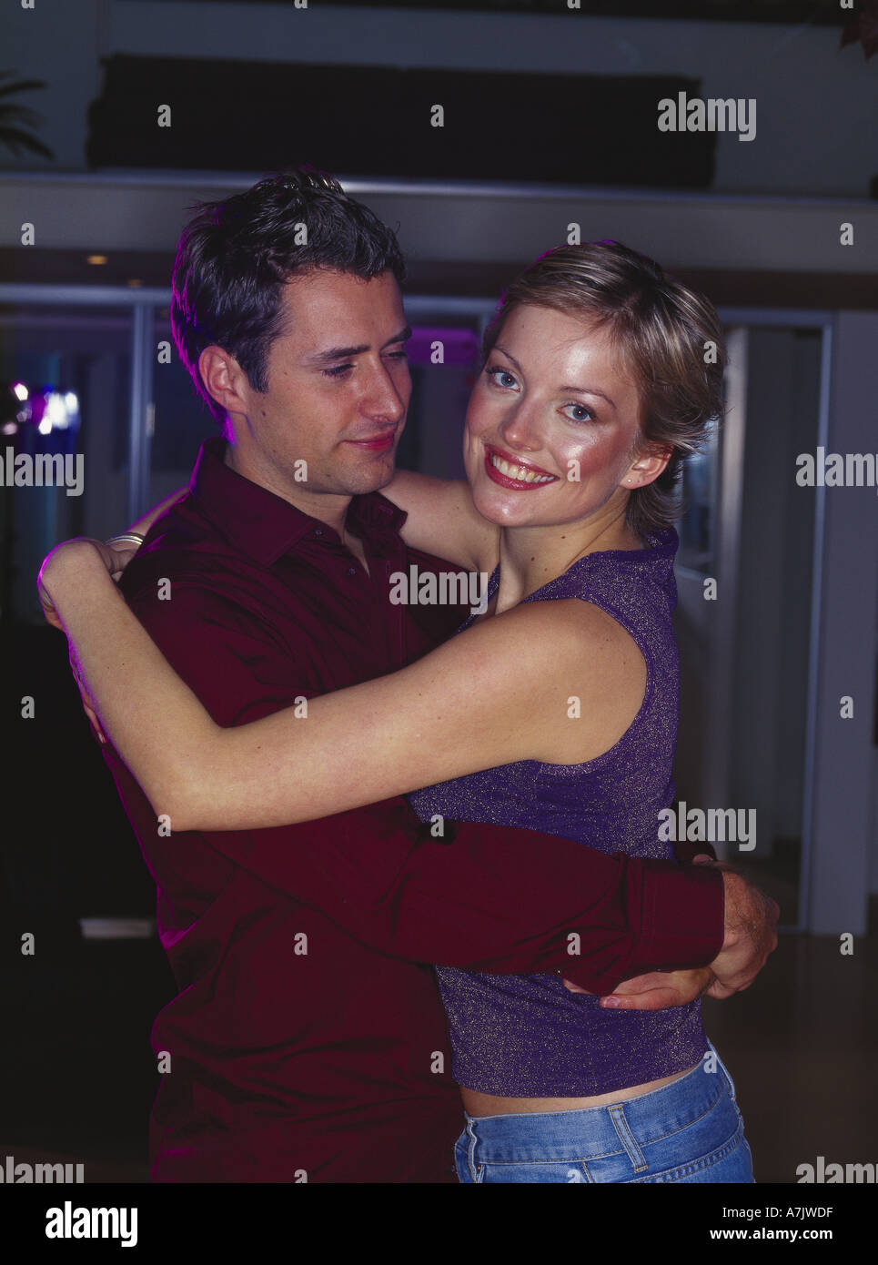 Side profile of a young couple hugging Stock Photo - Alamy