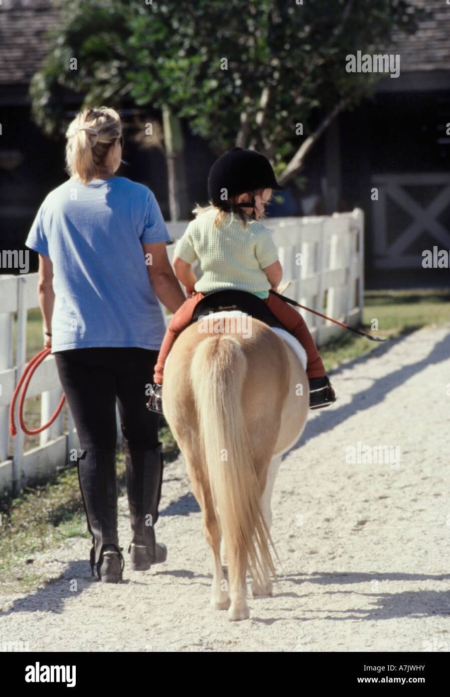 Daughter pony girl riding pony hi-res stock photography and images - Alamy