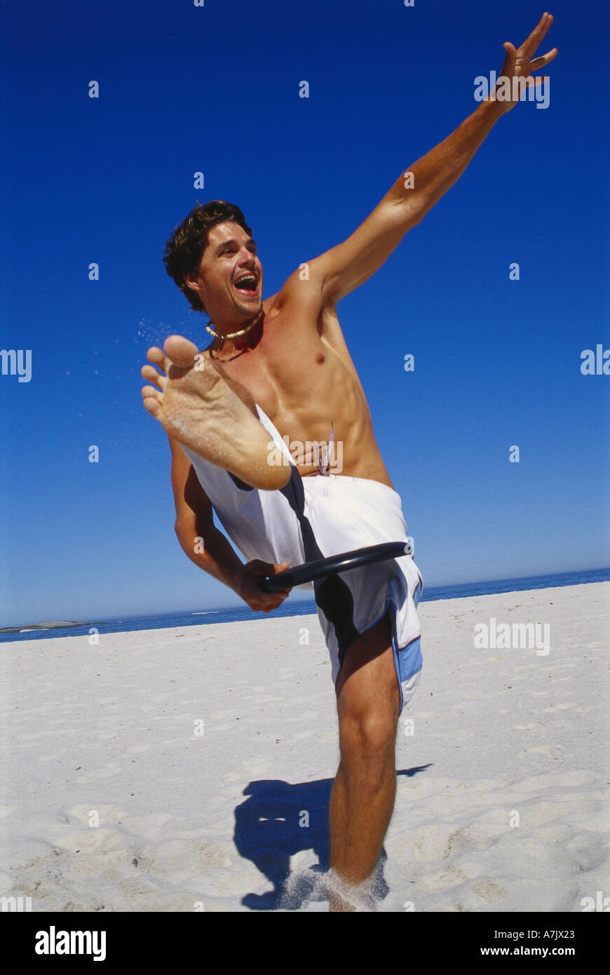 Young man standing on one leg hi-res stock photography and images - Alamy