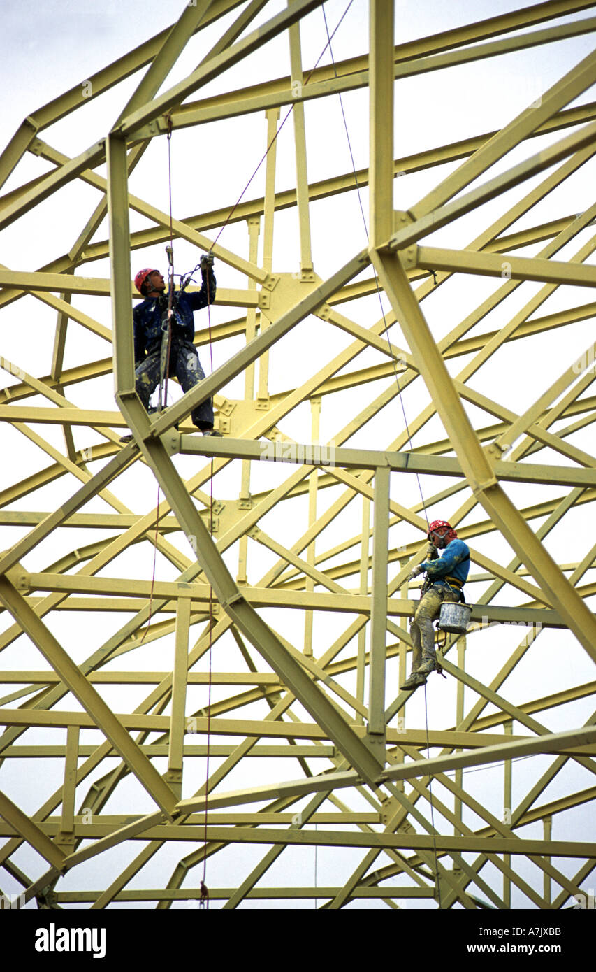 workmen painting the steel frame of the new grandstand of the Puskas ...