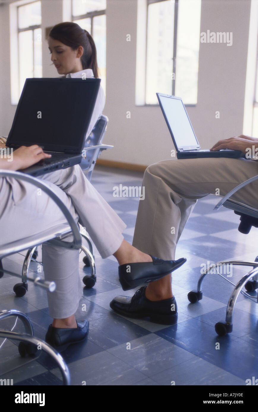 Three people working on laptops Stock Photo - Alamy