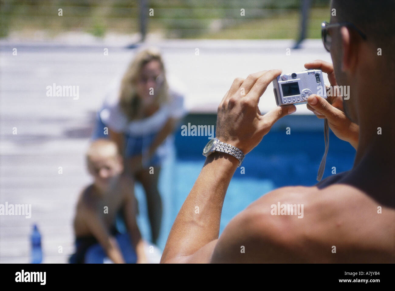 Rear view of a young man taking a picture with a camera Stock Photo - Alamy